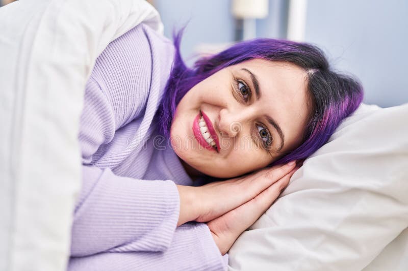 Young Beautiful Plus Size Woman Smiling Confident Lying on Bed at ...