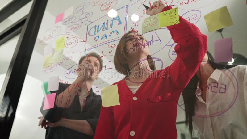 Young Beautiful Project Manager Writes Idea on Glass Board. Closeup ...