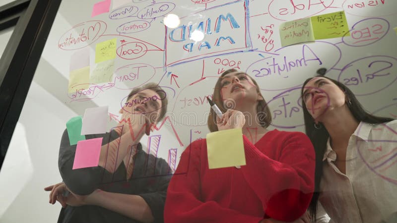 Young Beautiful Project Manager Writes Idea on Glass Board. Closeup ...