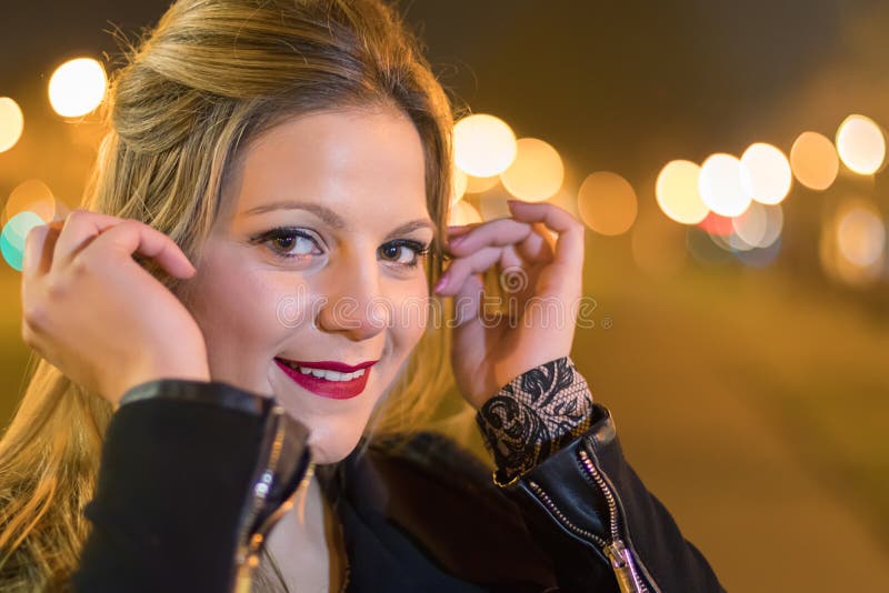 Young Beautiful Smiling Woman Against Night Lights Stock Image - Image ...