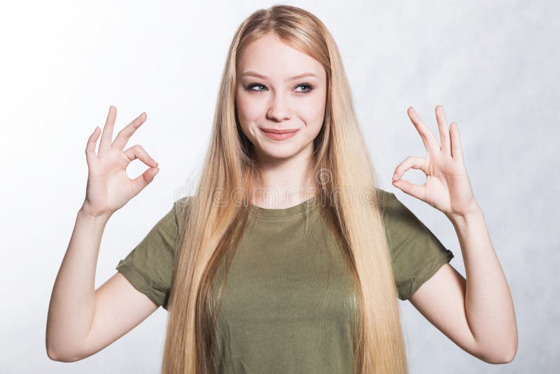 Young Beautiful Smiling Woman Shows Ok Sign. Body Language Concept ... Young Beautiful Smiling Woman Shows Ok Sign. Body Language Concept ...