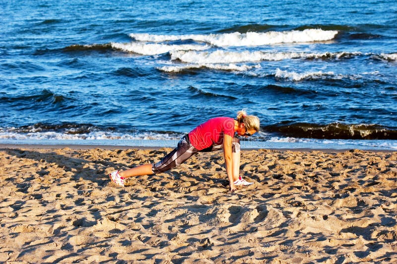 Exercises on the beach stock image. Image of active - 123576335