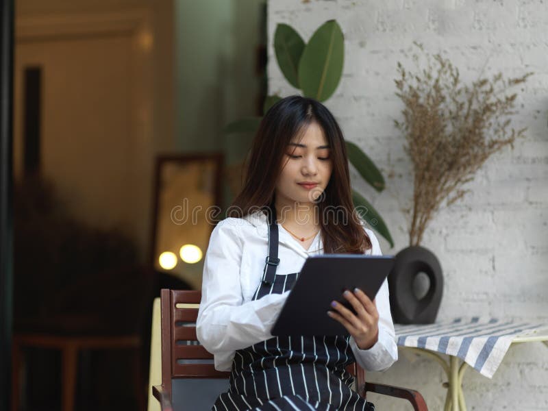 Young Beautiful Waitress Taking an Order on Digital Tablet in Front of ...