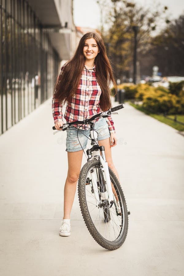 Young Beautiful Woman on a Bicycle Stock Image - Image of city, long ...
