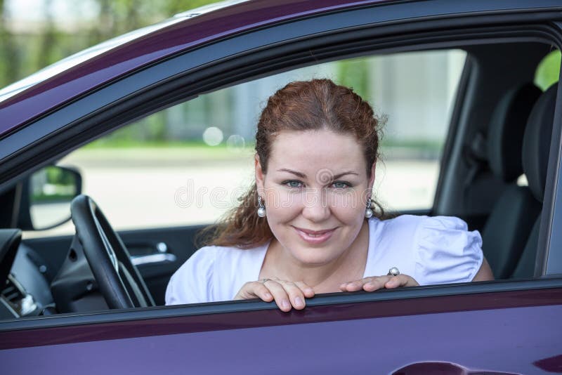 Young Beautiful Woman in Car Looking at Opened Window Stock Photo ...