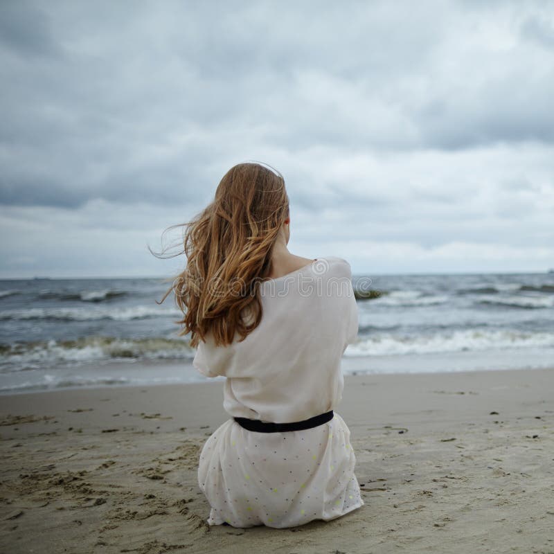 Young Beautiful Woman on Cold Windy Beach Stock Photo - Image of cloudy ...