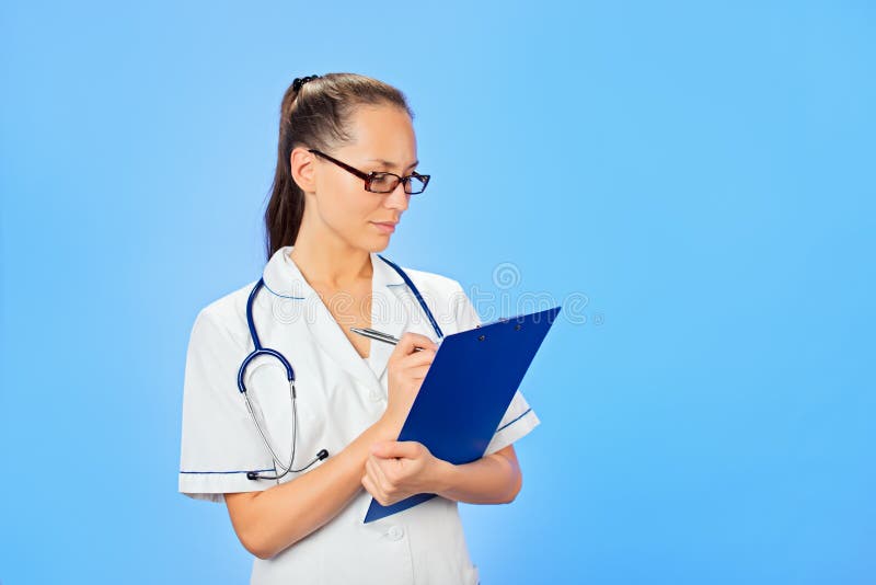Young Beautiful Woman Doctor Writing on Clipboard Stock Image - Image ...