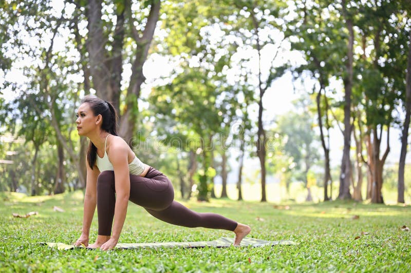 Young Beautiful Woman Doing Yoga Pose And Stretching Her Body At The