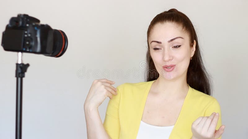 Young Beautiful Woman is Giving an Interview in Front of the Camera in ...