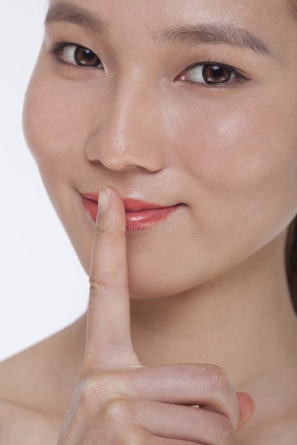 Young Beautiful Woman with Her Hands on Her Lips, Looking at Camera ...