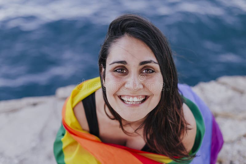 Young Beautiful Woman Holding A Rainbow Gay Flag Outdoors Lifestyle An