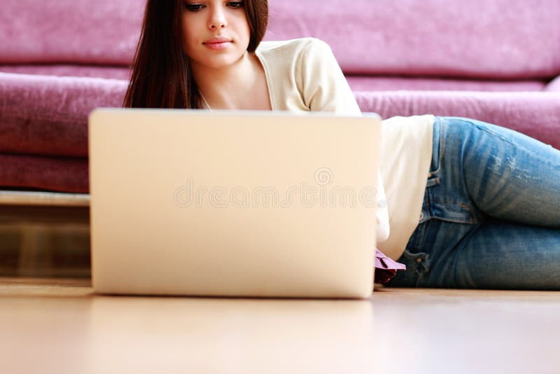Young Beautiful Woman Lying on the Floor and Using Laptop Stock Photo ...