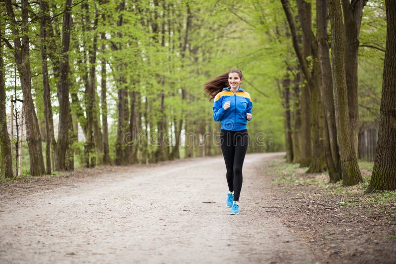 Young Beautiful Woman Running on a Trail Stock Photo - Image of ...