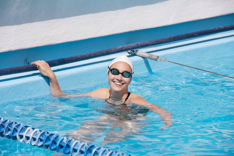Young Beautiful Woman With Swimsuit Swimming On A Blue Water Pool Stock