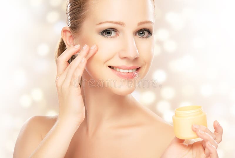 Young Beautiful Woman Using a Face Cream Stock Photo - Image of ...