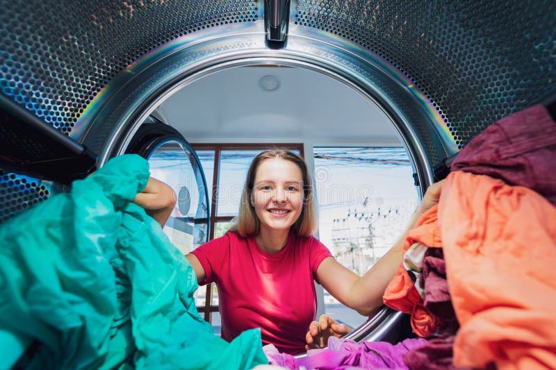 Young Beautiful Woman Washes and Dries Clothes in the Laundry Stock ...