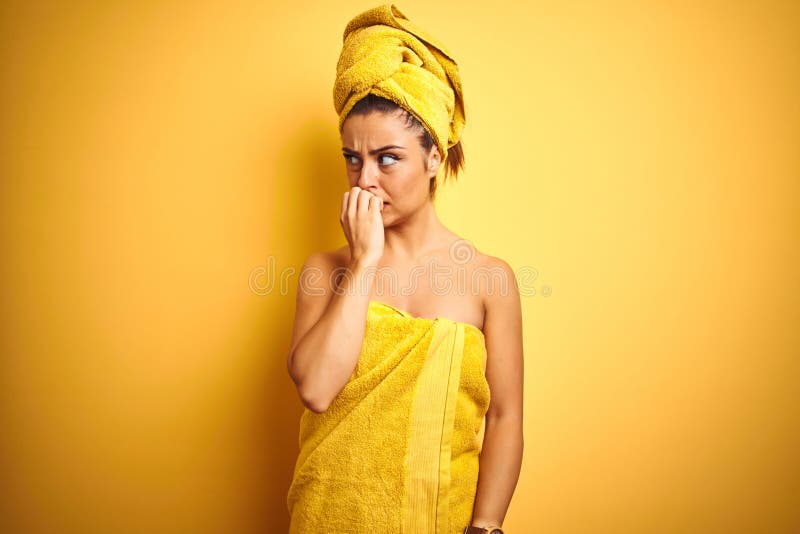 Young Beautiful Woman Wearing Towel After Shower Over Isolated Yellow