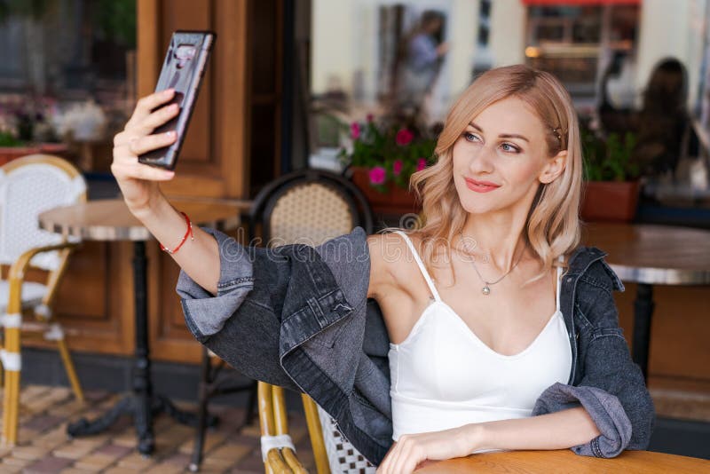 Young Beautiful Woman With White Hair Takes Selfie On Smartphone Happy