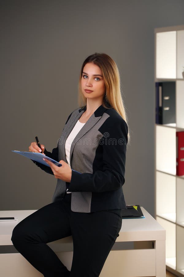 Young Beauty in the Office and Jacket Holding Documents Stock Photo ...