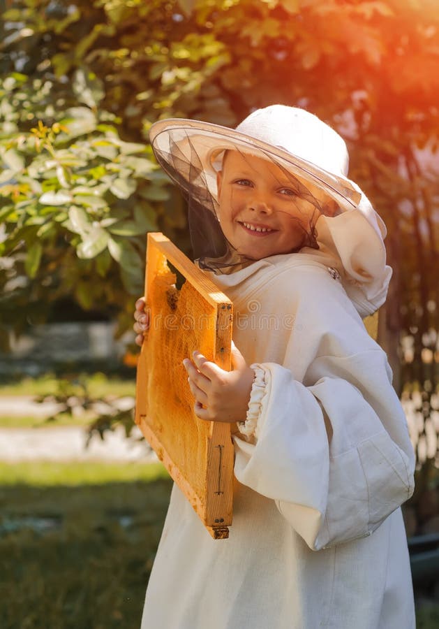 Young Beekeeper Boy Holding Frame of Honeycomb Stock Photo - Image of ...