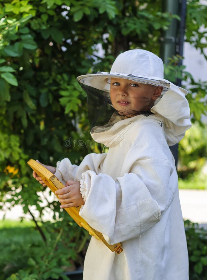 Young Beekeeper Boy Holding Frame of Honeycomb Stock Image - Image of ...
