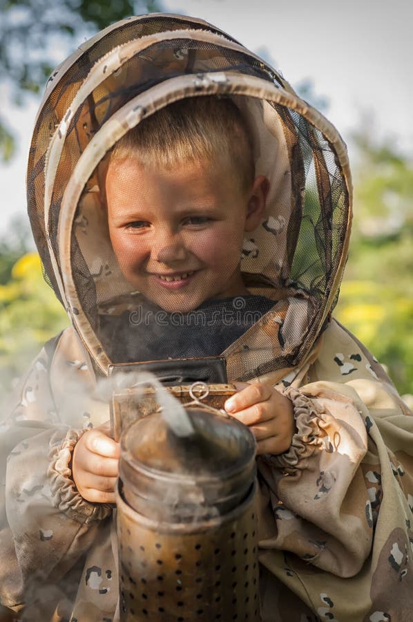 Young Beekeeper Boy Using a Smoker on Bee Yard Stock Image - Image of ...