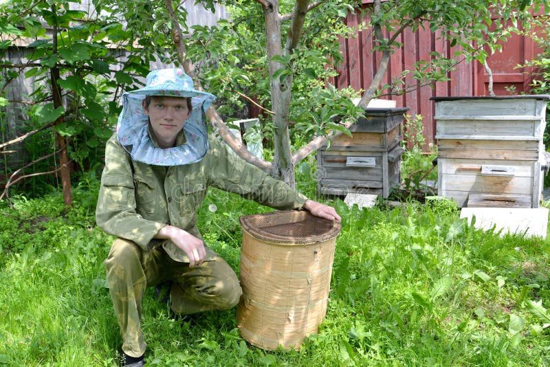 The Young Beekeeper from Swarms To it on an Apiary Stock Image - Image ...