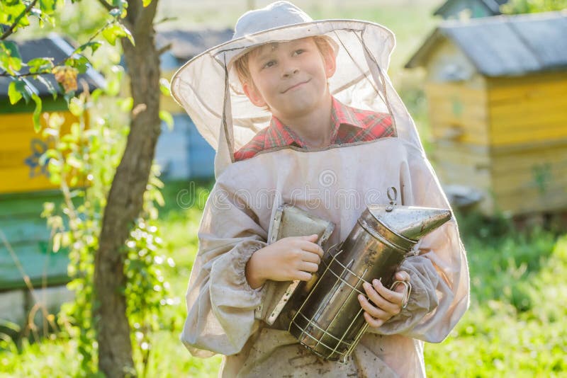 Young Beekeeper Using a Smoker on Bee Yard Stock Photo - Image of hobby ...