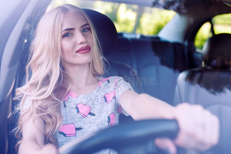 A Young Beutiful Girl is Driving a Car. Stock Image - Image of ...