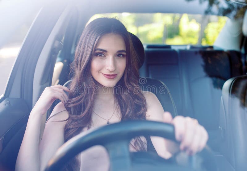 Cute Brunette Girl in the Car. Elegant Business Woman Driving a Car ...