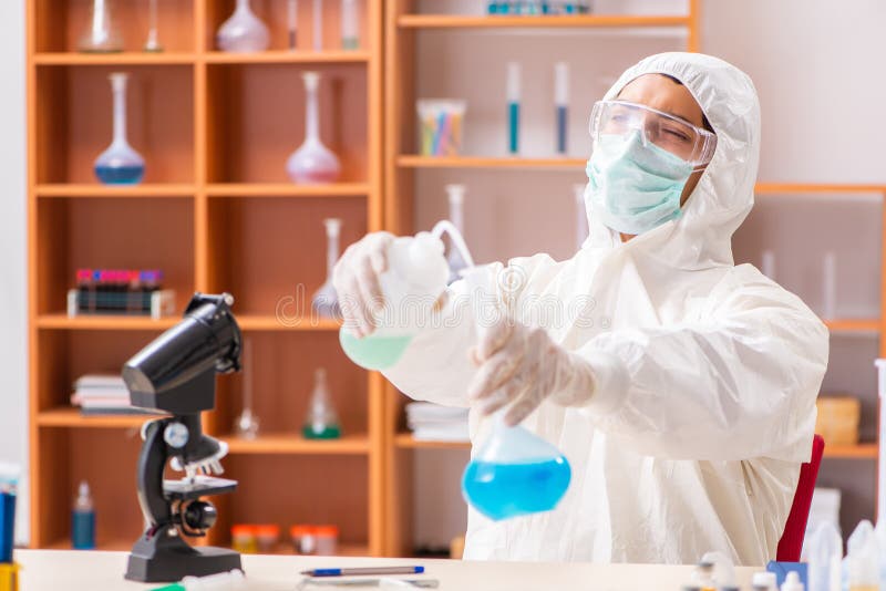 The Young Biochemist Wearing Protective Suit Working in the Lab Stock ...