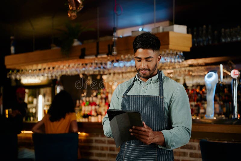 Young Biracial Man in Apron Using Digital Tablet while Working As ...