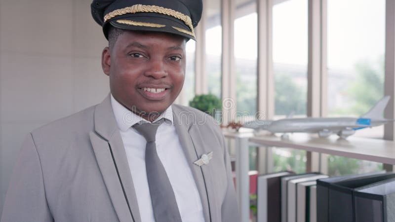 A Young Black African Pilot Smiles in the Office Stock Video - Video of ...