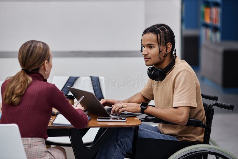 Young Black Boy with Disability Studying in College Library with Friend ...