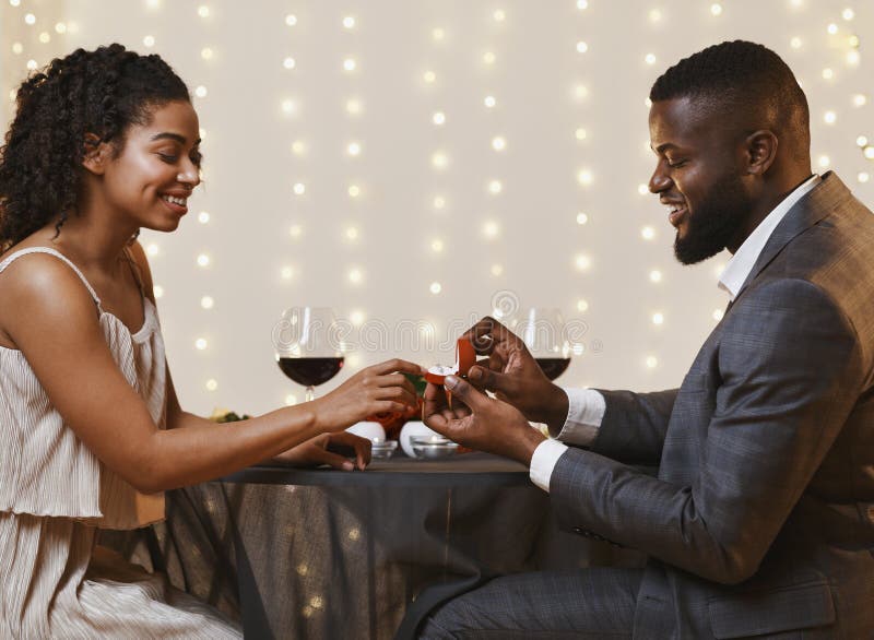 Young Black Couple Getting Engaged in Restaurant Stock Photo - Image of ...