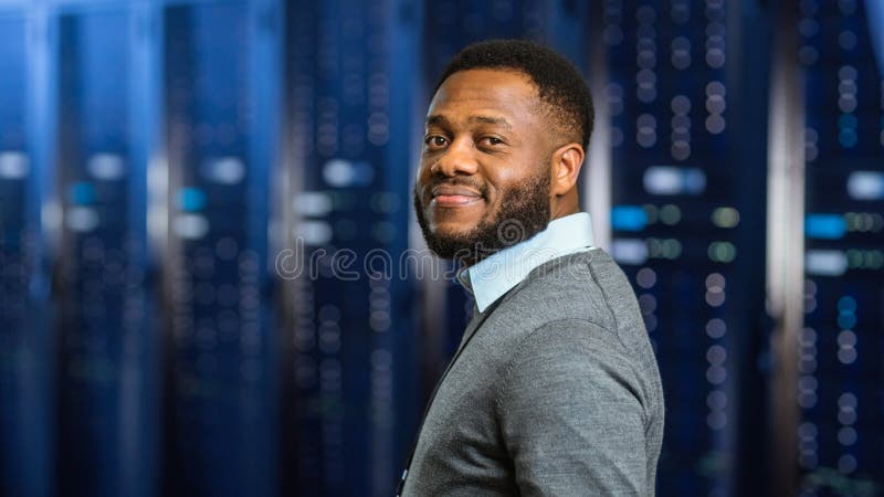 Young Black Data Center it Technician Standing in Server Rack Corridor ...