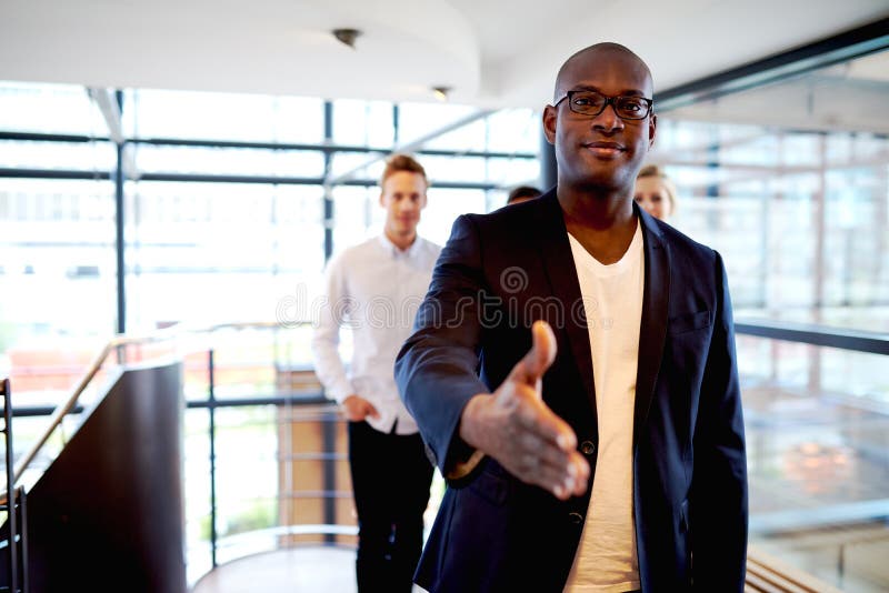 Young Black Executive Facing Camera with Hand Out. Stock Image - Image ...
