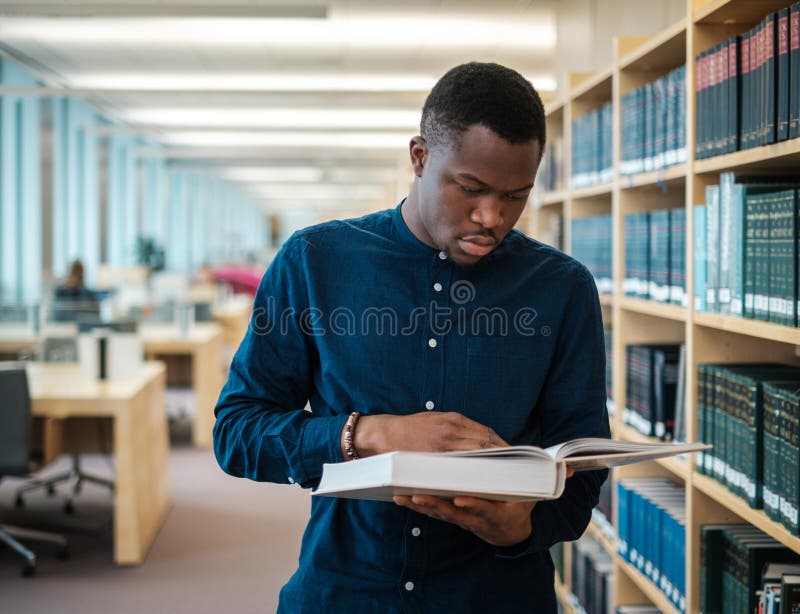 Young Black Man Choosing Book in Public Library Stock Photo - Image of ...