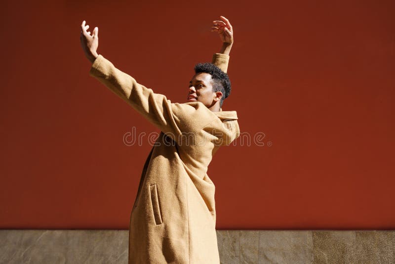 Young Cuban Man Dancing on Red Urban Wall. Stock Image - Image of ...