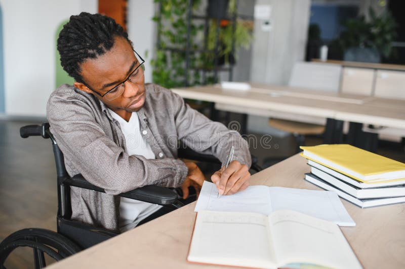 Focused Student in Wheelchair Taking Notes in Modern Office Stock Image ...