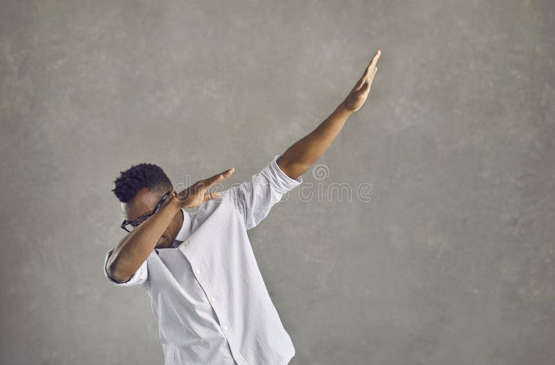 Young Black Man Doing Popular Dab Dance Move Isolated On Gray Concrete ...