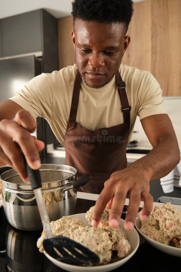 Young Black Man Preparing Boiled Chicken Mince with Vegetables Recipe ...