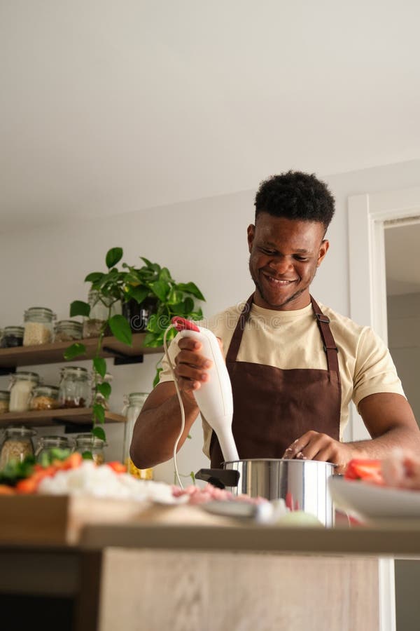 Young Black Man Using a Blender To Prepare Chicken Mince. Stock Photo ...