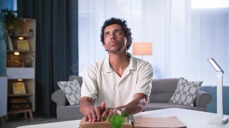 Young Black Man with Vision Problems Studying a Book for the Blind ...