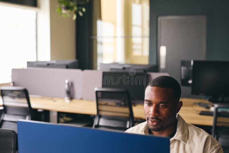 Young Black Man Working on Computer in Modern Office at Desk Stock ...