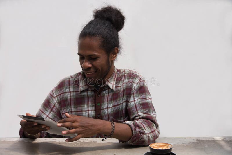 A Young Black Man Working and Studying Holding Laptop and Pen Doing ...
