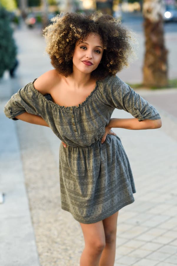 Young Black Woman With Afro Hairstyle Smiling In Urban Park Stock Image