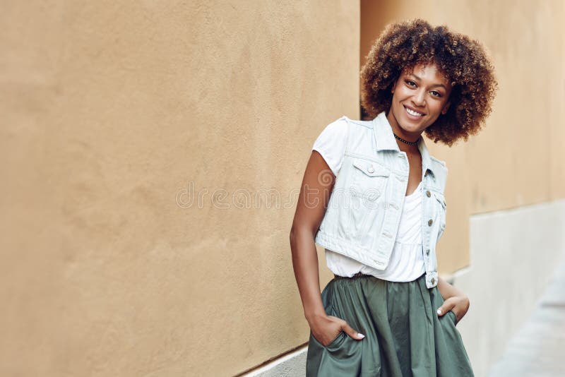 Young Black Woman Afro Hairstyle Smiling In Urban Background Stock