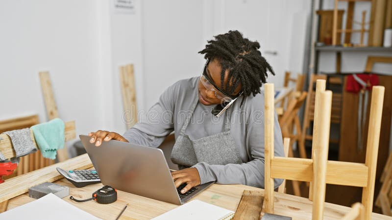 Young Black Woman with Dreadlocks Multitasking in a Carpentry Workshop ...