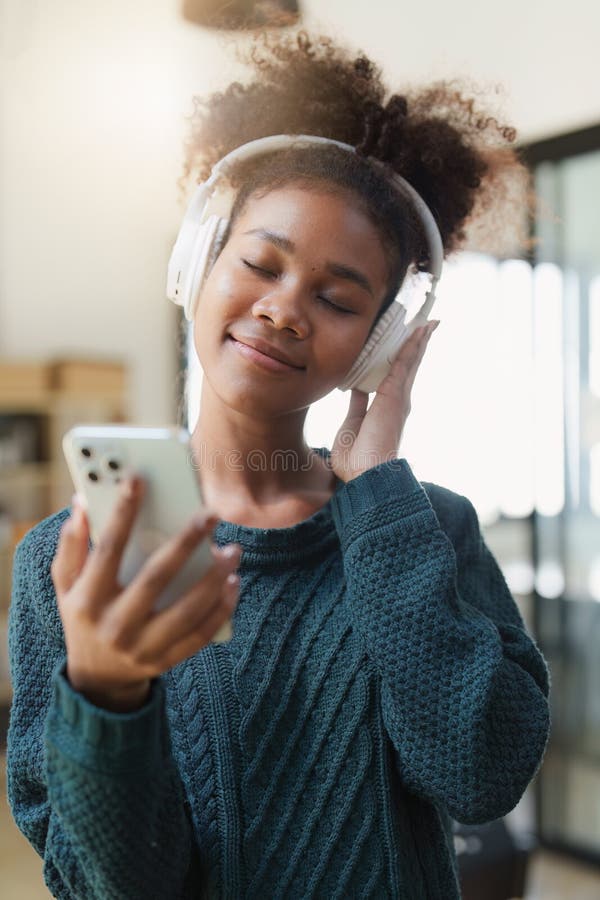 Young Black Woman Listening To Music Online Wearing Wireless Earphones